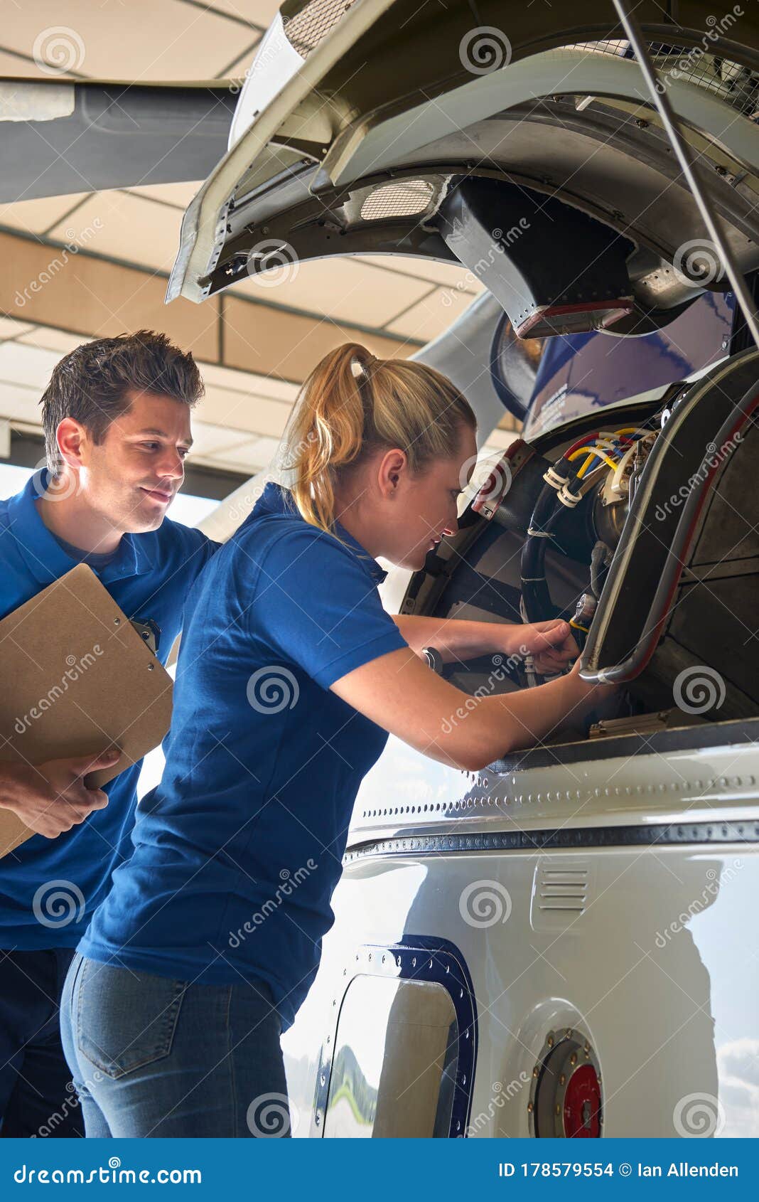 Aero Engineer and Apprentice Working on Helicopter in Hangar Stock ...