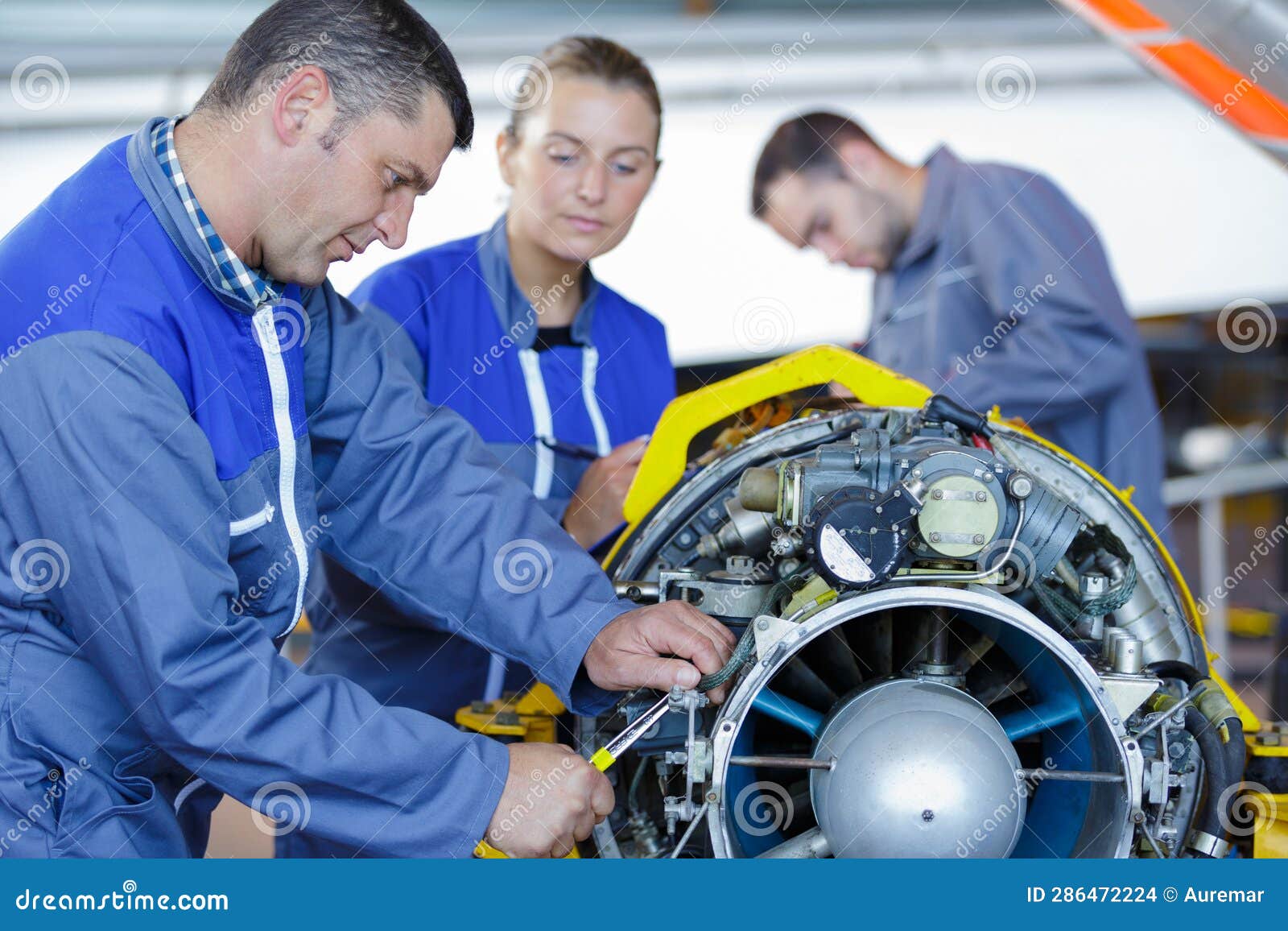 Aero Engineer and Apprentice Working on Helicopter in Hangar Stock ...