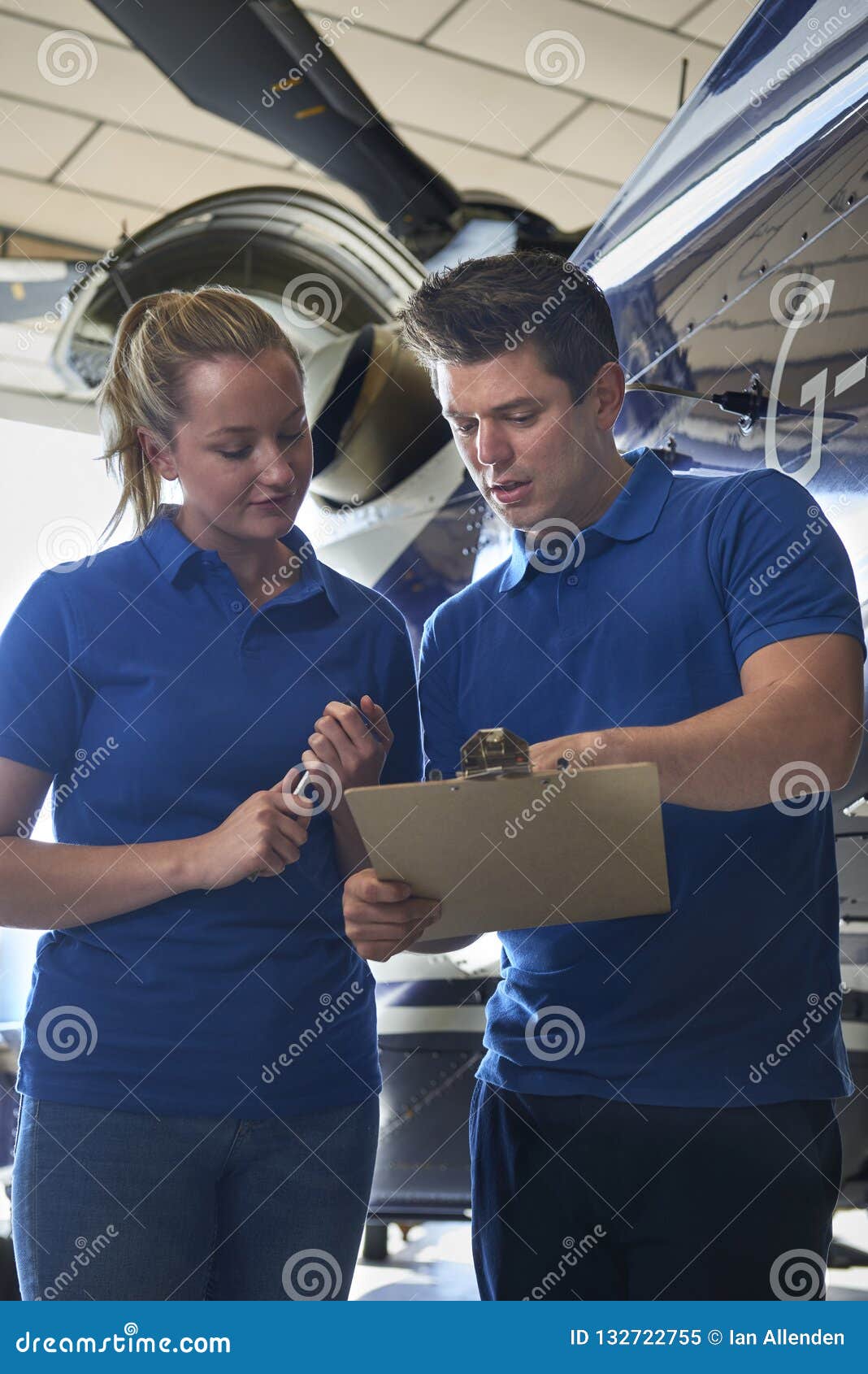 Aero Engineer and Apprentice Working on Helicopter in Hangar Loo Stock ...