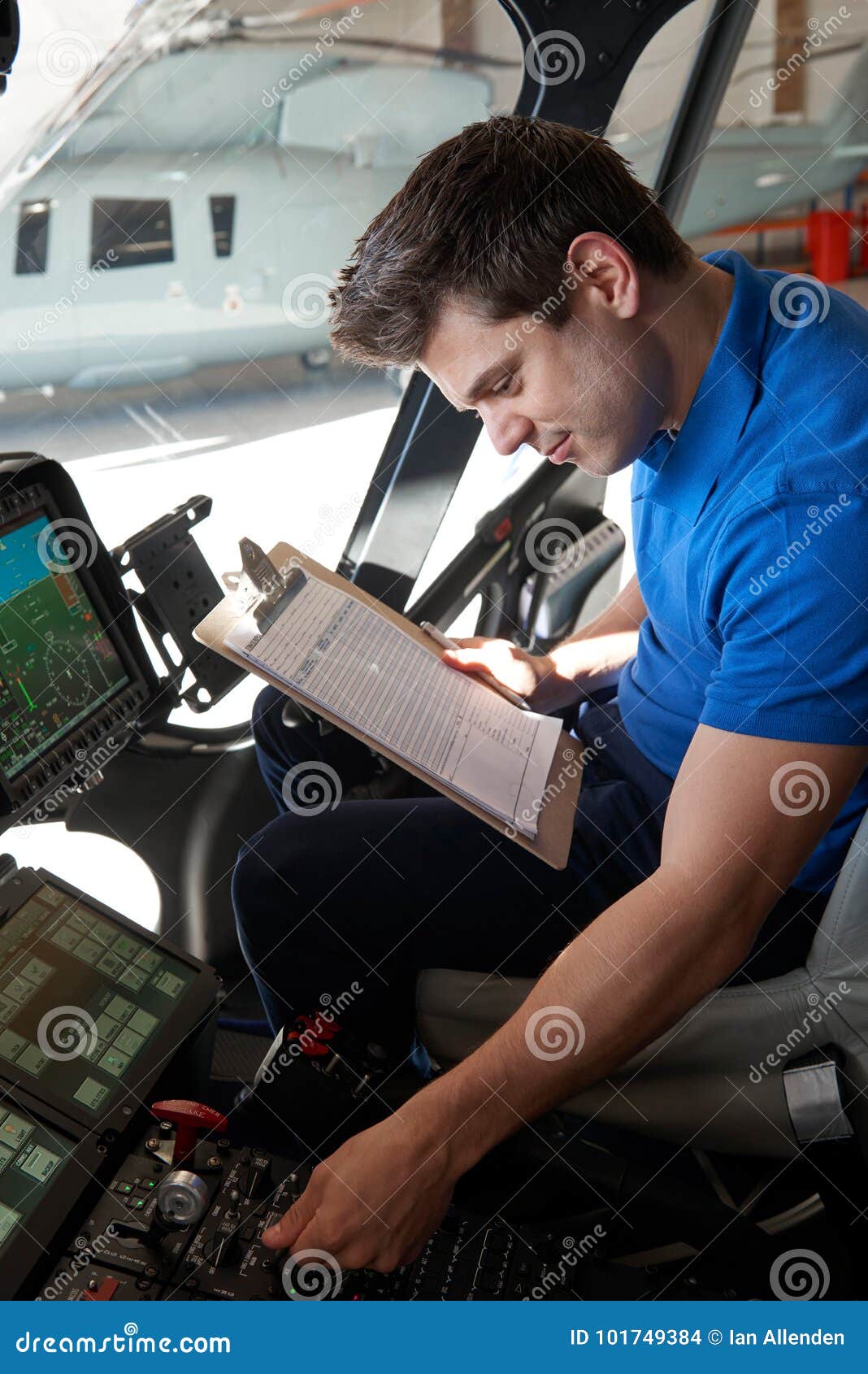 Male Aero Engineer with Clipboard Working in Helicopter Cockpit Stock ...