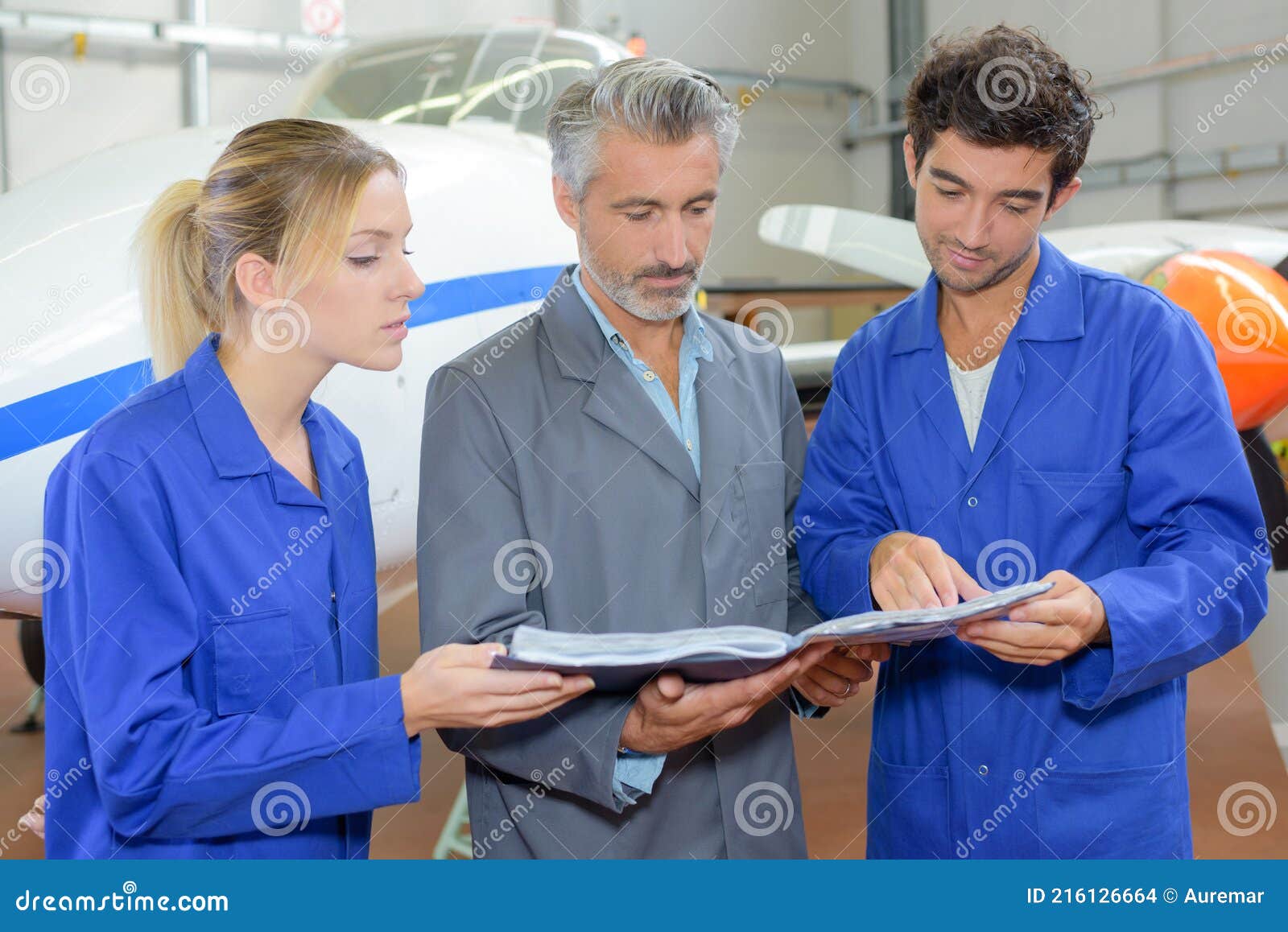 Aero Mechanic Students and Teacher Revising Task Stock Photo - Image of ...