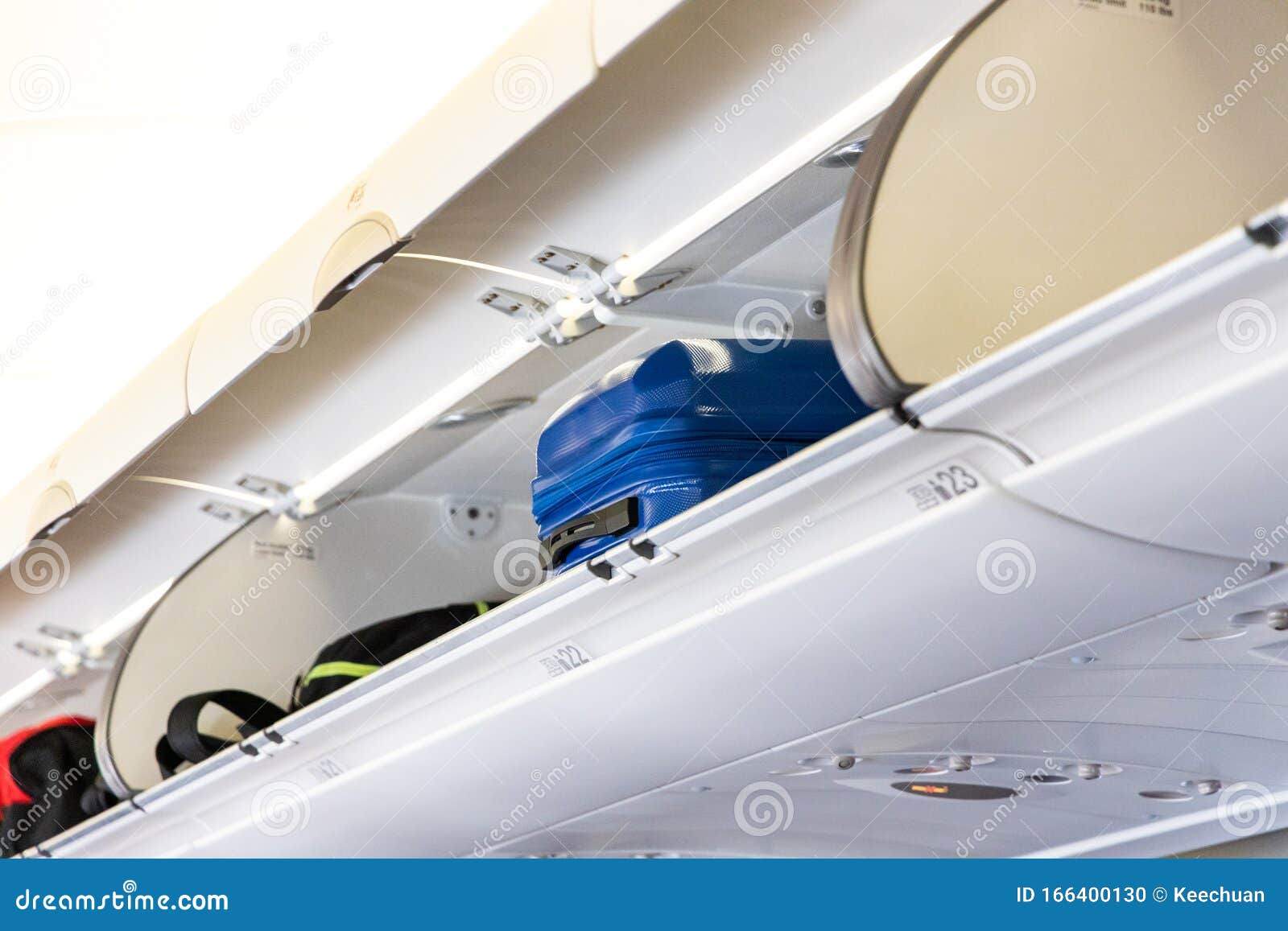 Aeroplane Overhead Luggage Compartment with Bags Stock Photo - Image of ...