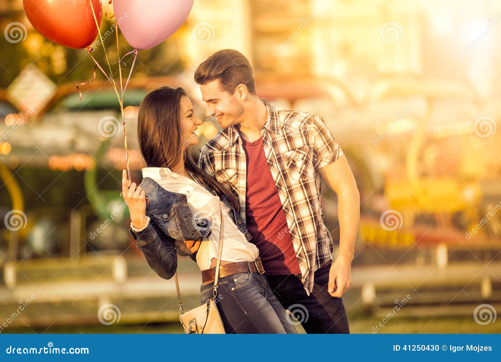 Affectionate Couple Having Fun in Amusement Park Stock Photo - Image of ...