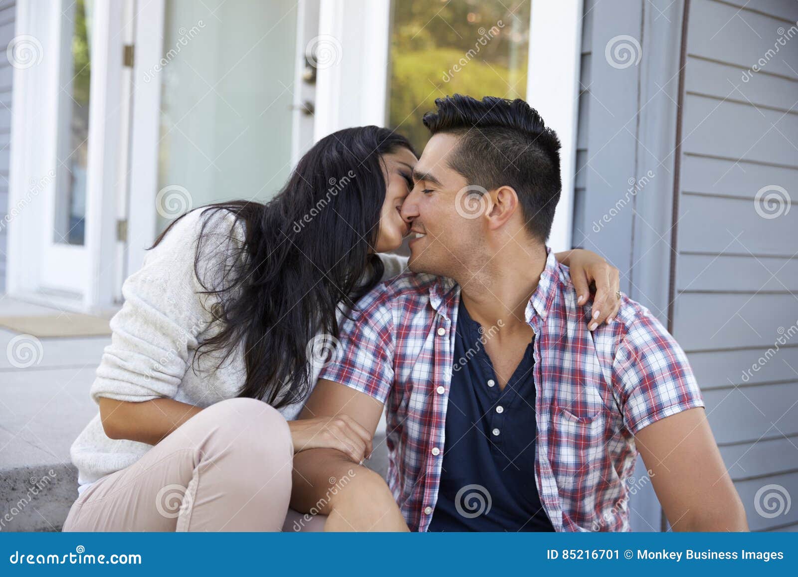 Affectionate Couple Sitting on Steps Outside Home Stock Image - Image ...