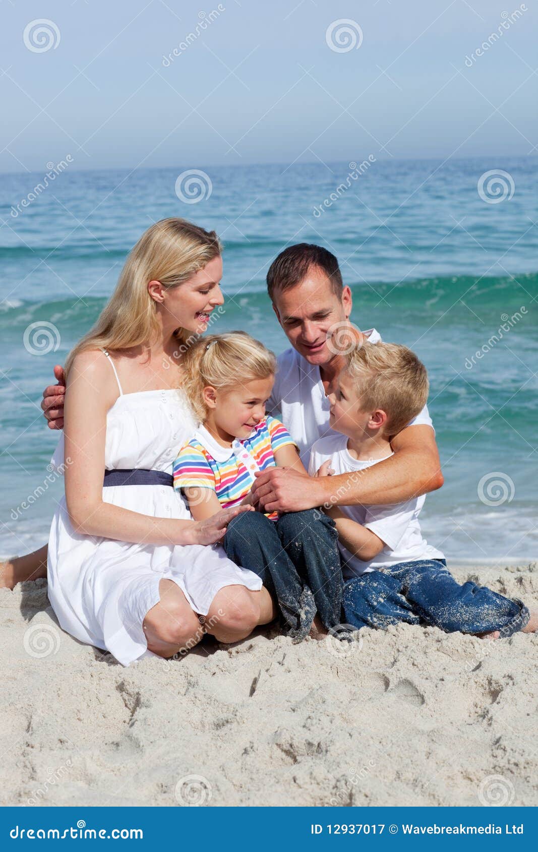 Affectionate Family Sitting on the Sand Stock Image - Image of blue ...