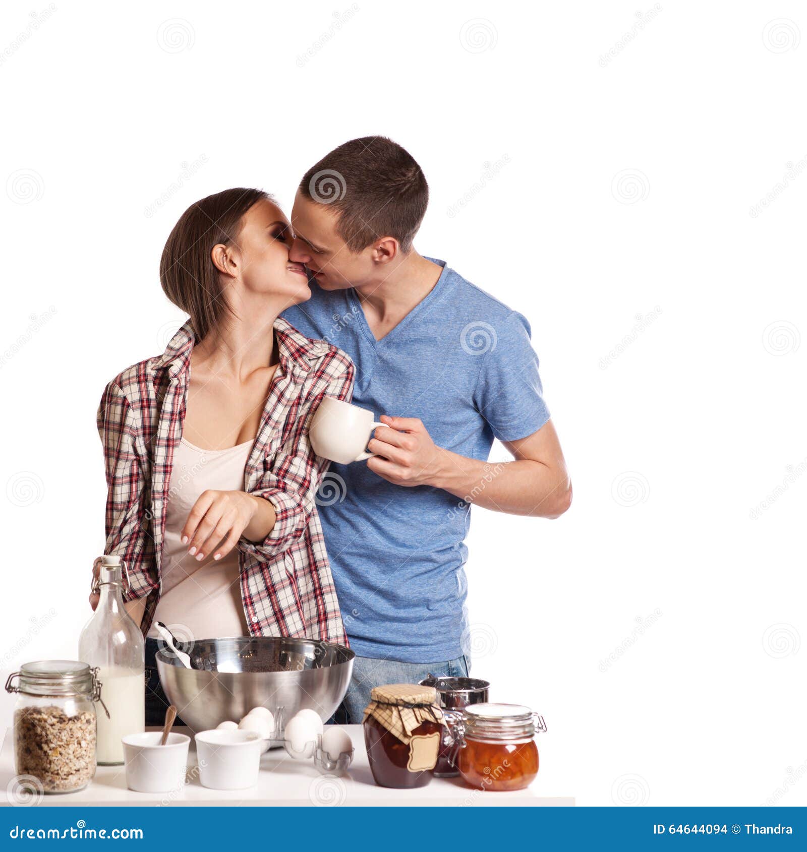 Affectionate Man Kissing His Girlfriend while Cutting Bread for ...