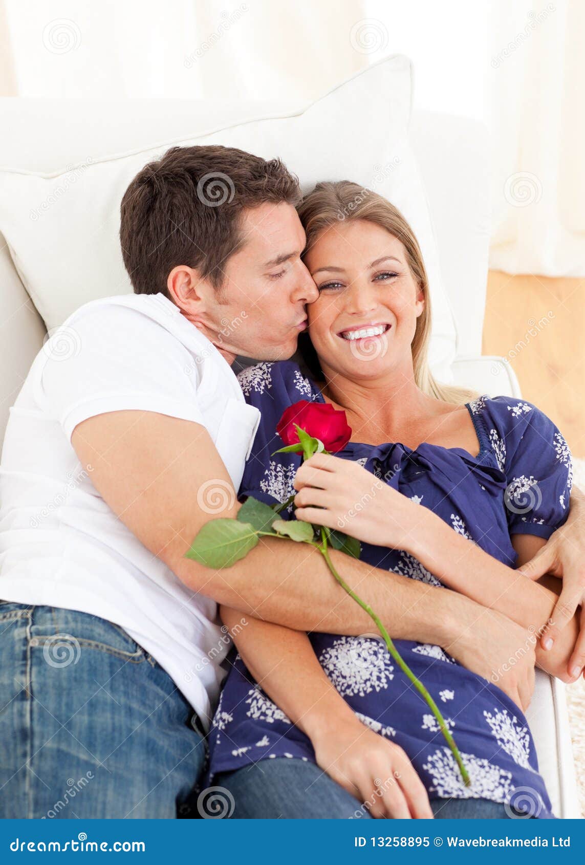 Affectionate Man Kissing His Wife Lying on Sofa Stock Image - Image of ...