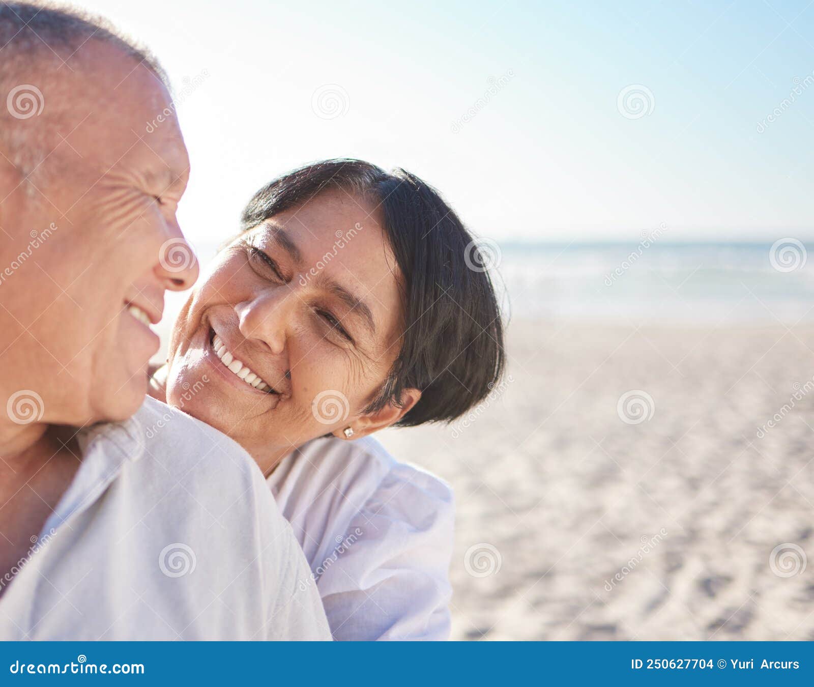 Affectionate Mature Mixed Race Couple Sharing An Intimate Moment On The