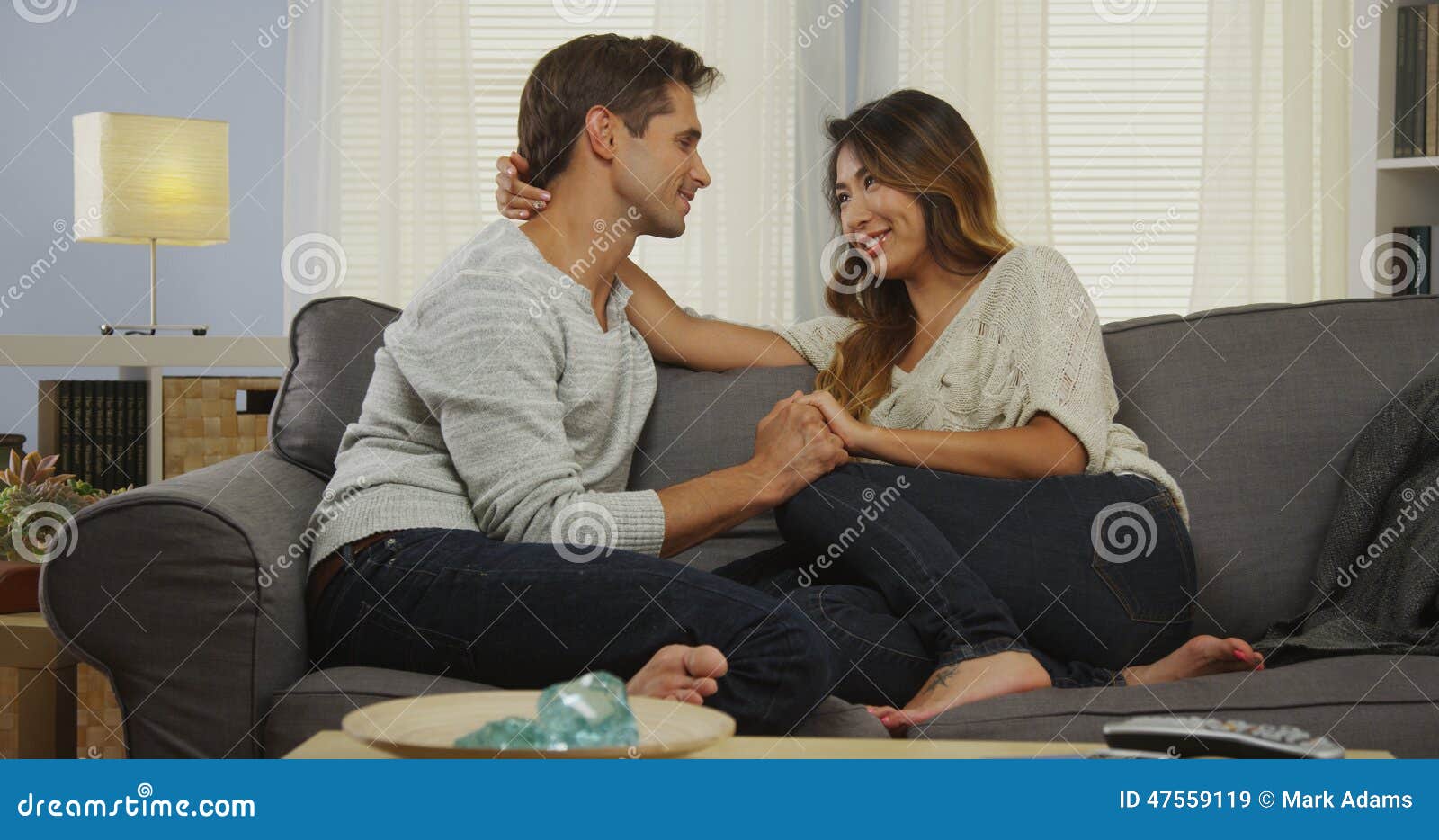 Affectionate Mixed Couple Talking On Couch Stock Image Image Of Happy
