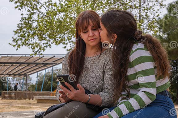 Affectionate Moment of a Daughter Kissing Her Mother Stock Photo ... Affectionate Moment of a Daughter Kissing Her Mother Stock Photo ...