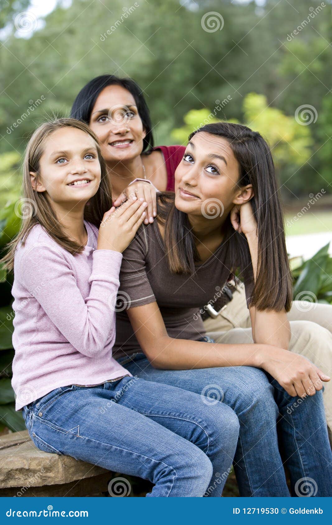 Affectionate Mother and Two Daughters Smiling Stock Photo - Image of ...