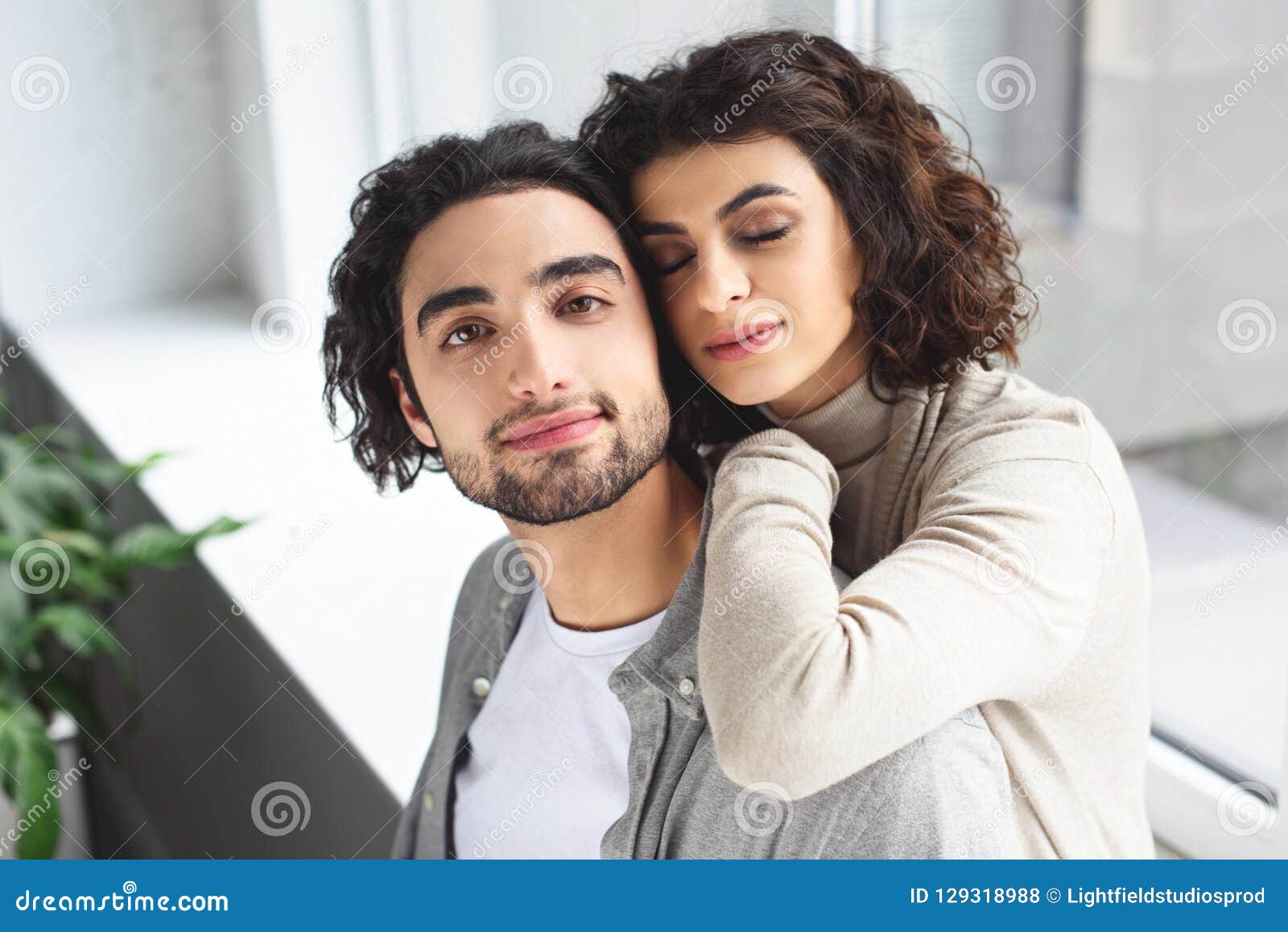 Affectionate Young Couple Cuddling Stock Photo - Image of male, indoors ...