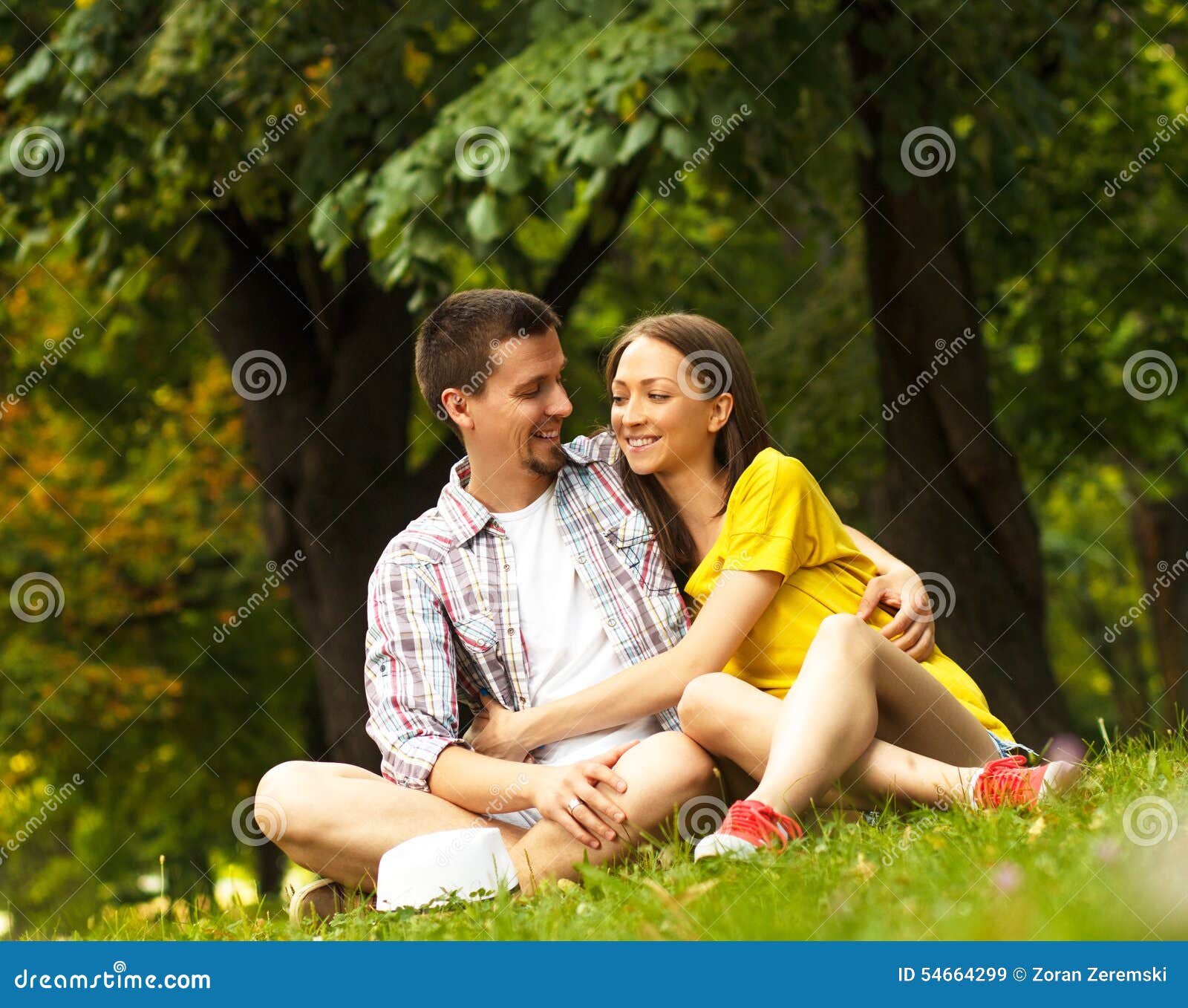 Affectionate young couple stock image. Image of grass - 54664299