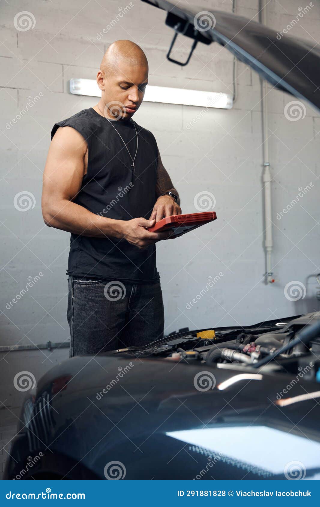 African American Auto-mechanic Diagnosing Car Electric System Using ...