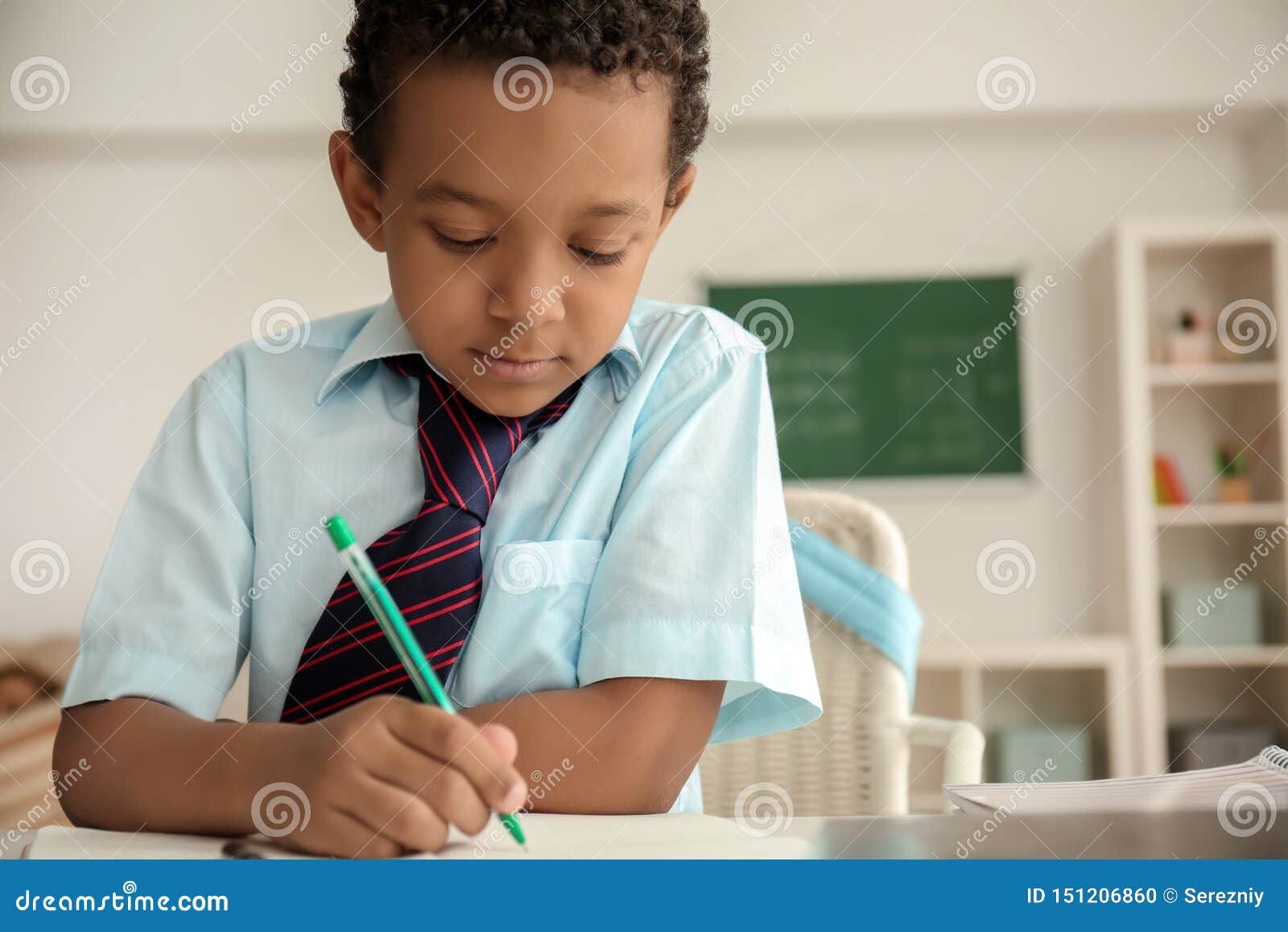 African-American Boy Doing Exercise in Classroom Stock Photo - Image of ...