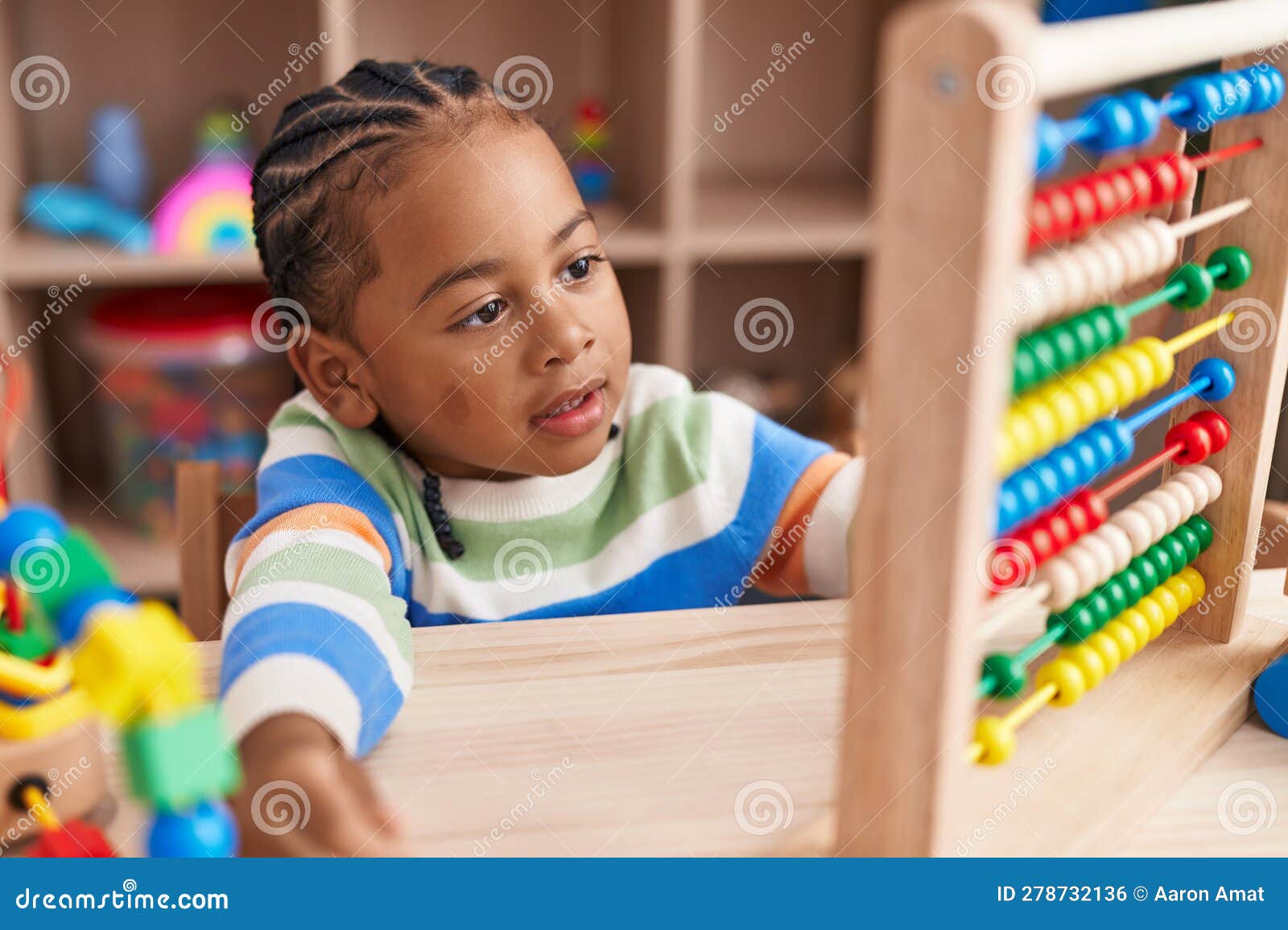 African American Boy Playing with Abacus Sitting on Table at ...