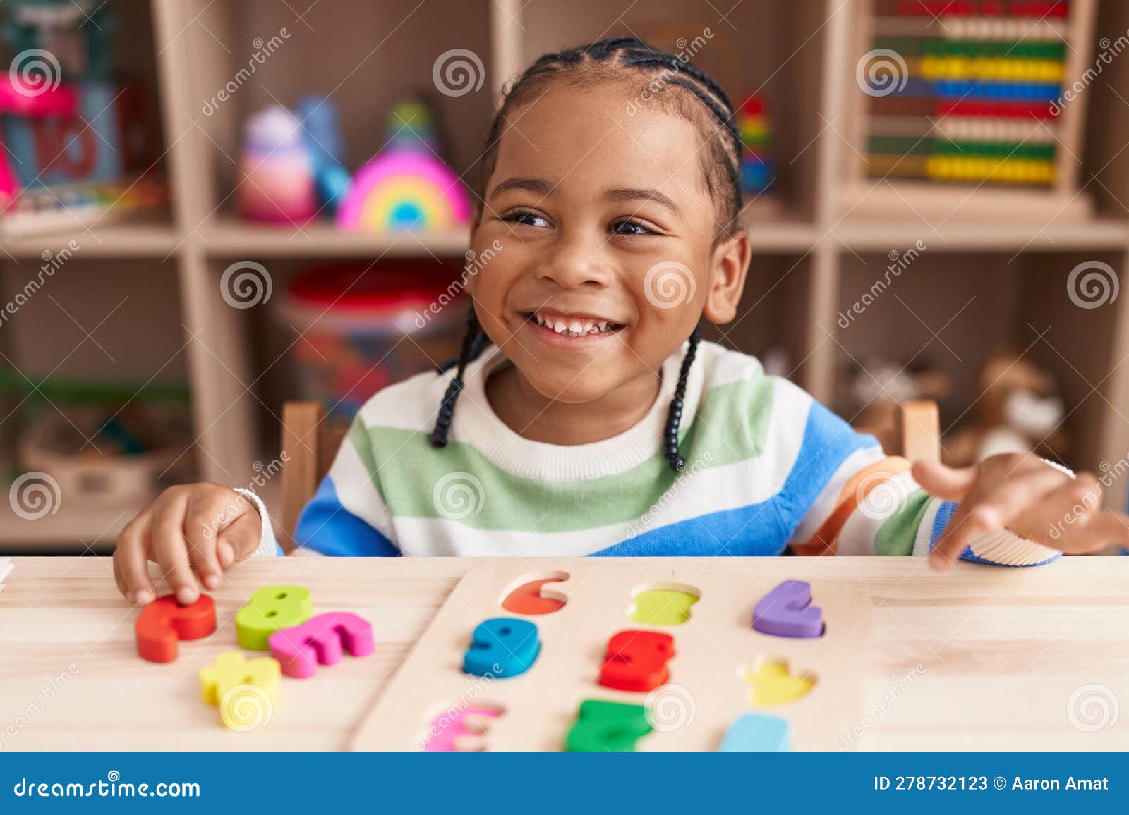 African American Boy Playing with Maths Puzzle Game Sitting on Table at ...