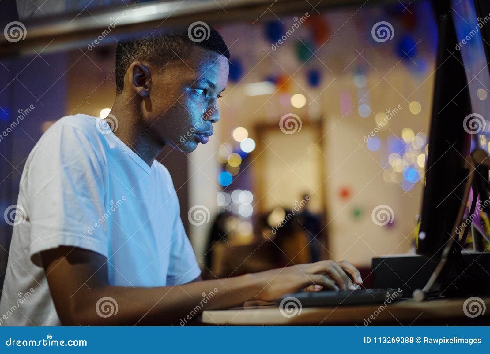 African American Boy Using a Computer at Night Stock Photo - Image of ...