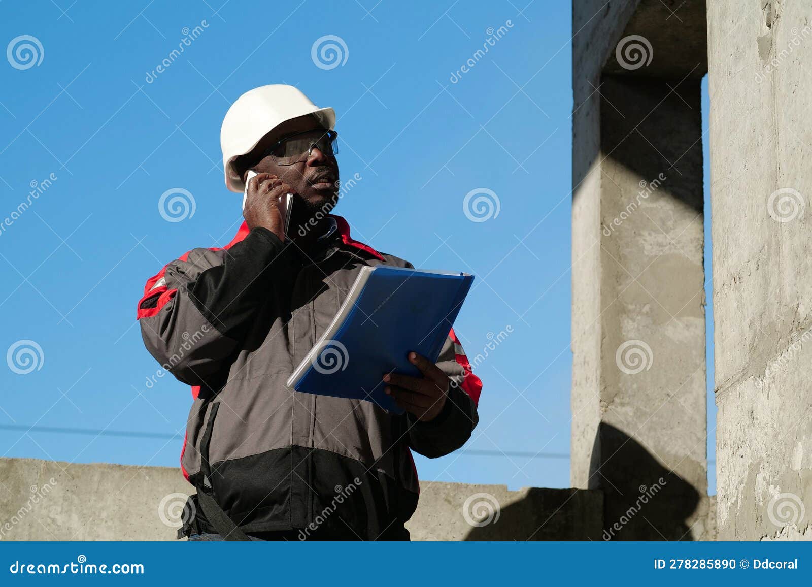 African American Builder with Work Papers Talks on Smartphone Stock ...