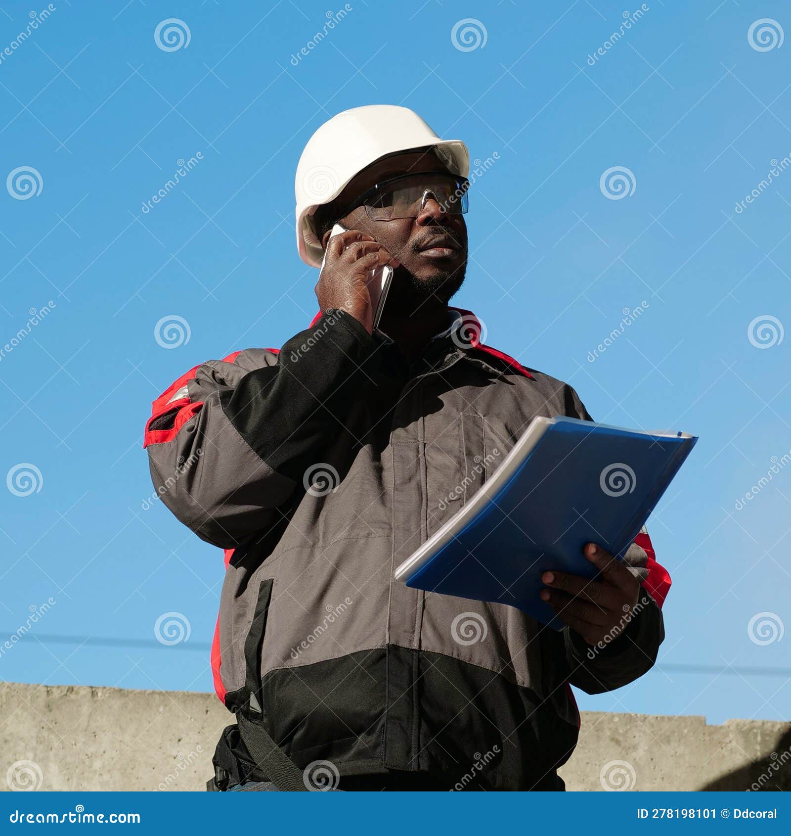 African American Builder with Work Papers Talks on Smartphone Stock ...
