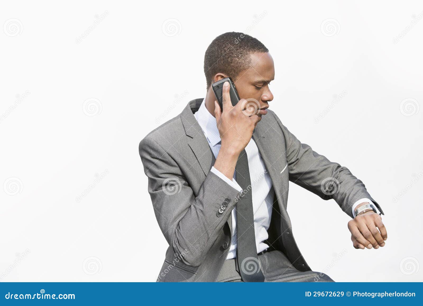 African American Businessman Checking Time while on a Call Stock Image ...
