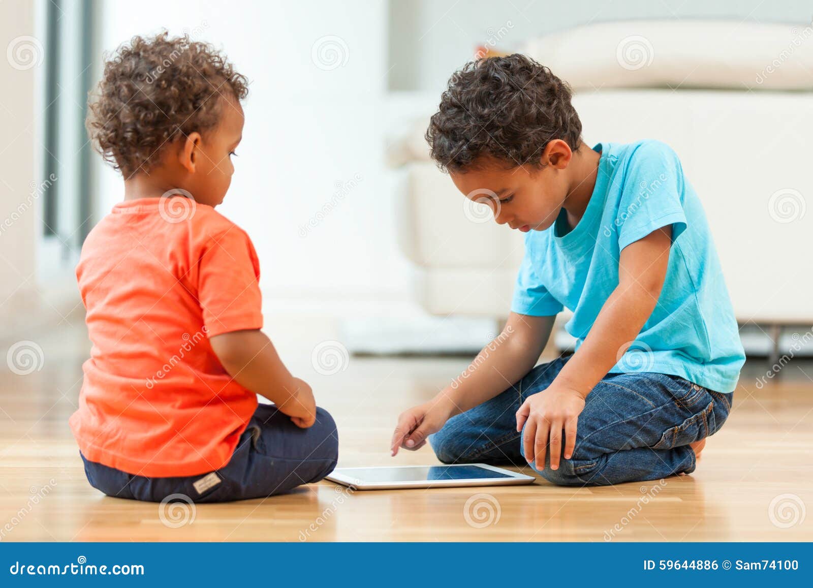 African American Childrens Using a Tactile Tablet Stock Photo - Image ...