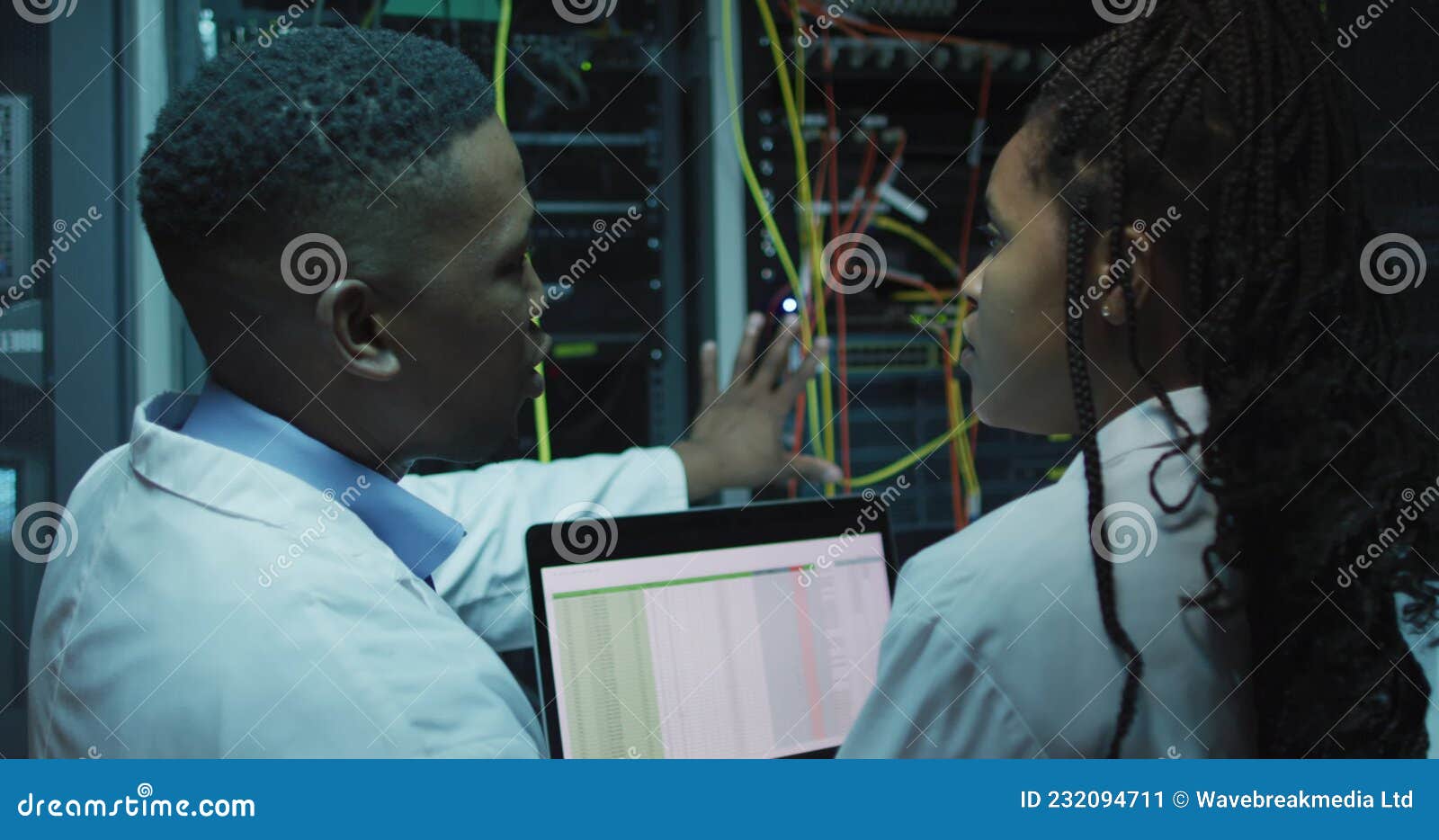 African American Computer Technicians Using Tablet Working in Business ...