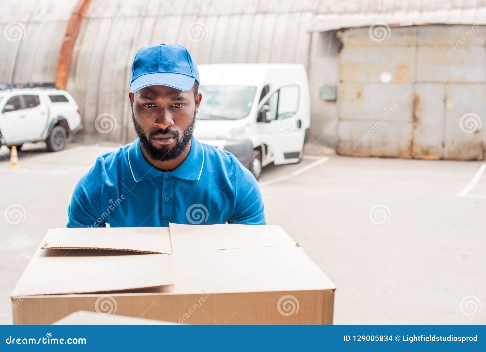 African American Courier Carrying Big Stock Photo - Image of ...