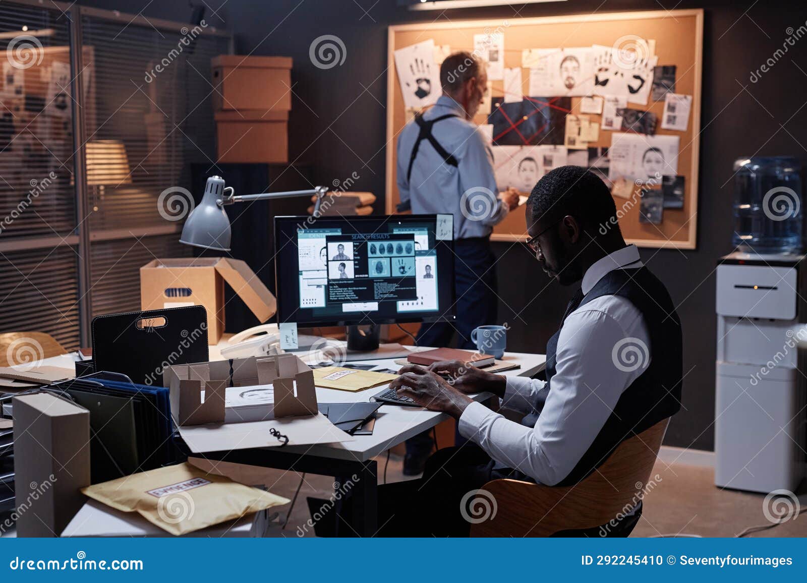 African American Detective Using Computer at Workplace Stock Photo ...