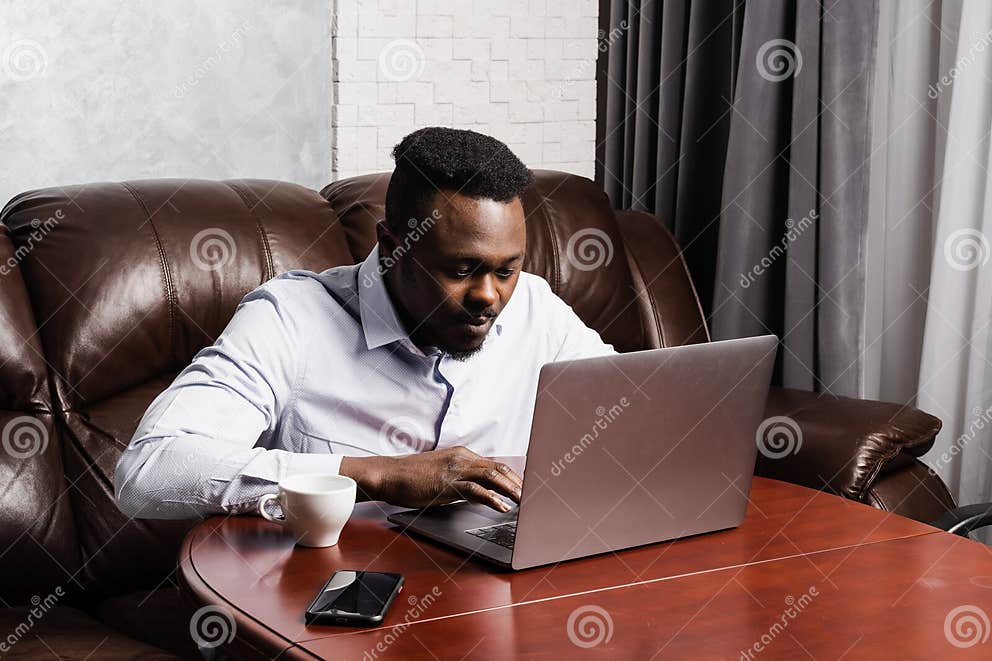African American it Developer with Laptop is Programming Code in Office. African Business Man ...