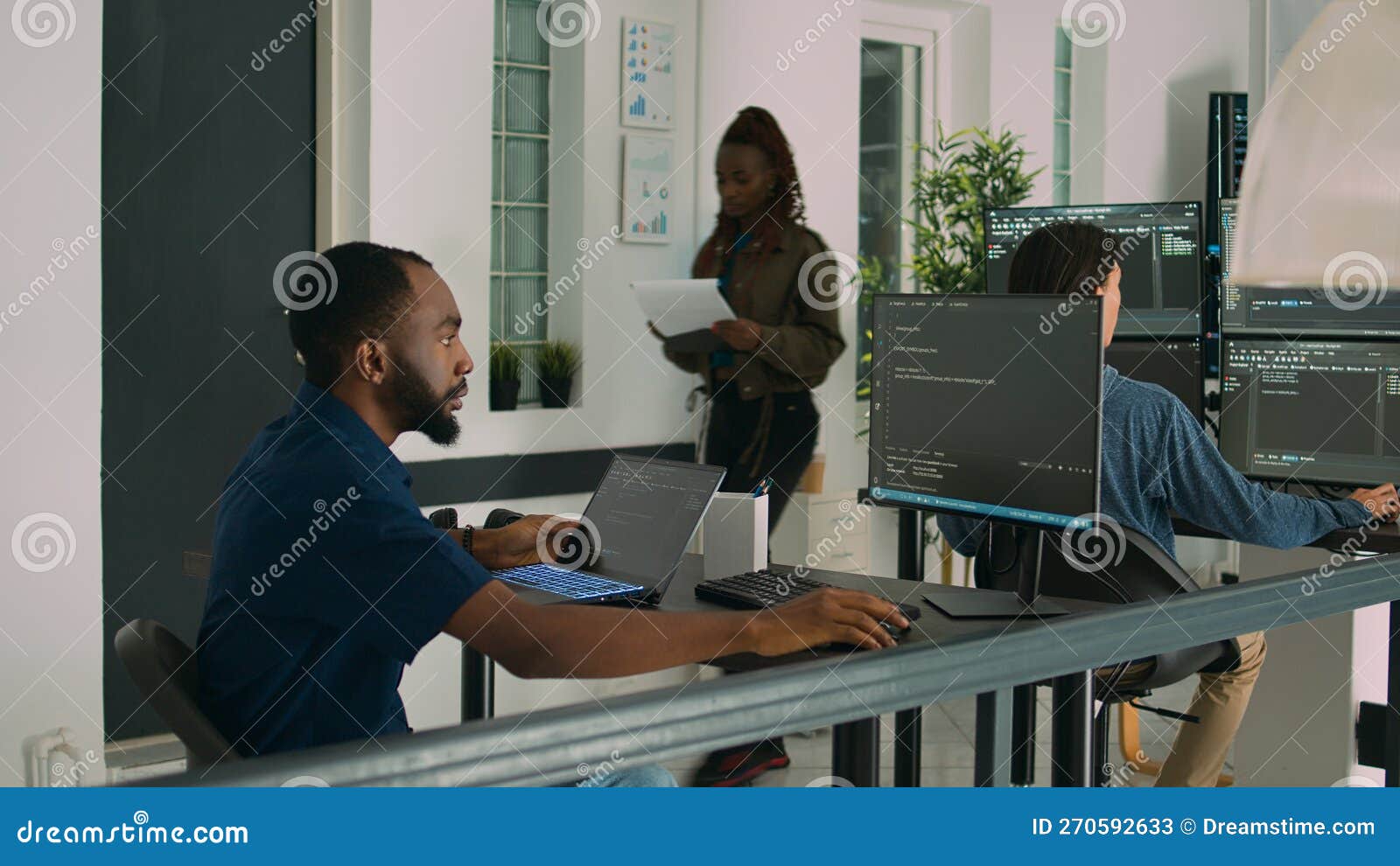 African American Developer Using Laptop To Write Code and Display System Information Stock Image ...