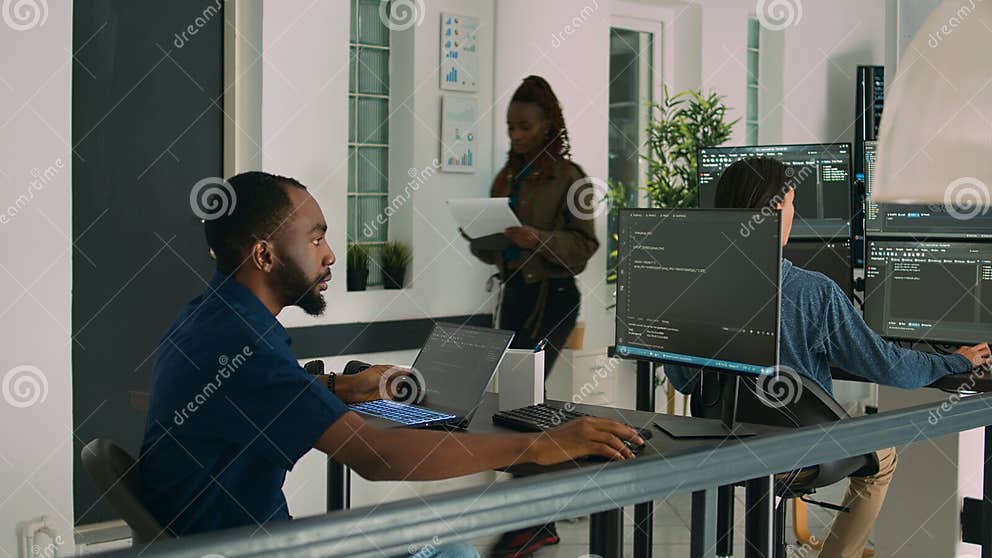 African American Developer Using Laptop To Write Code and Display System Information Stock Image ...
