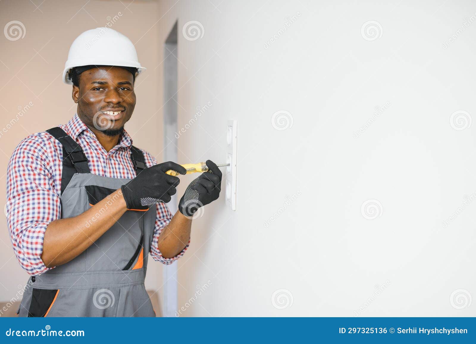 African-American Electrician Using Socket Voltage Regulator in Room ...