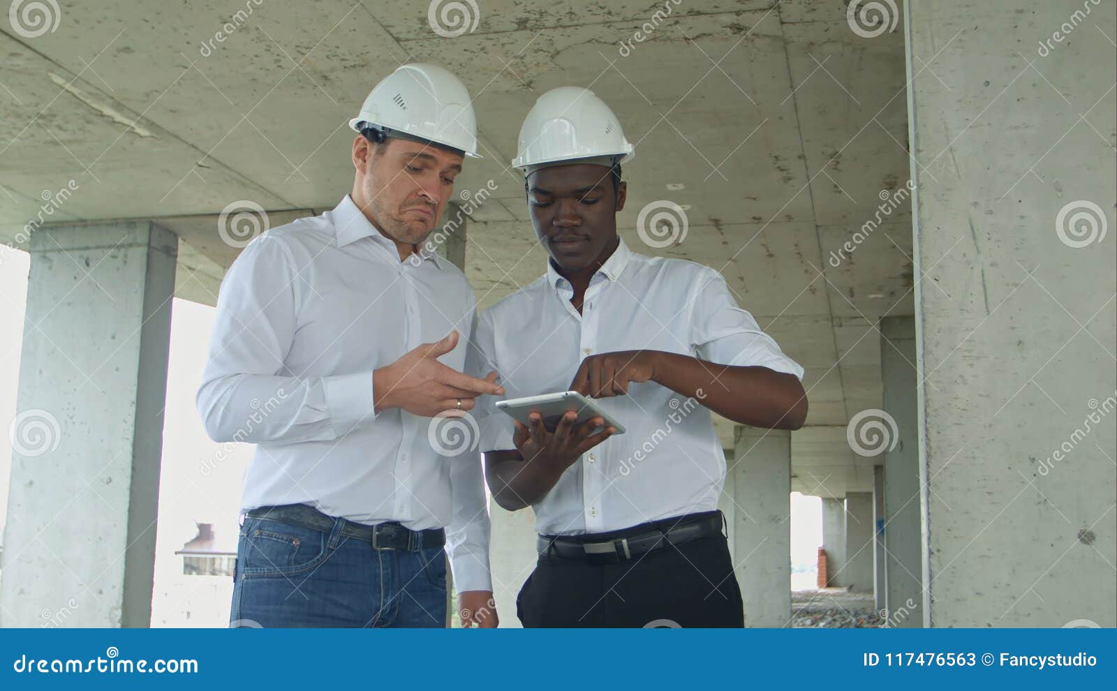 African American Engineer and Caucasine Architect Using Digital Tablet ...