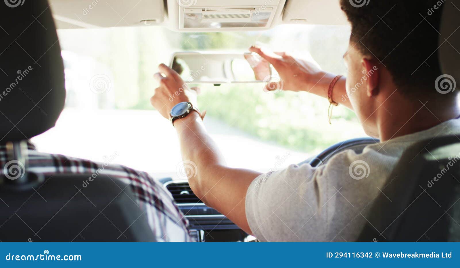 African American Father Instructing Son About Rear View Mirror Before