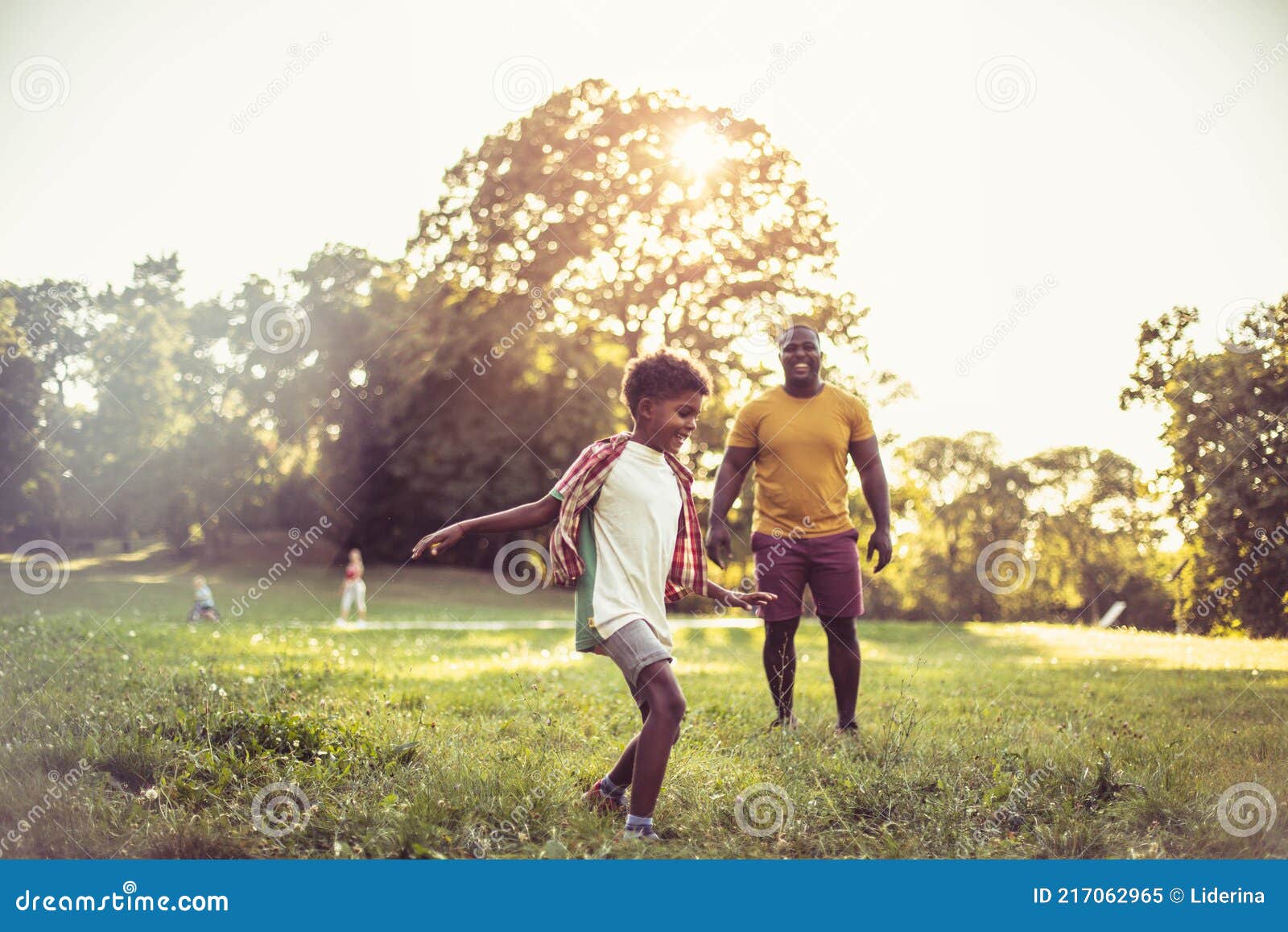African American Father And Son Having Fun In Nature Stock Image