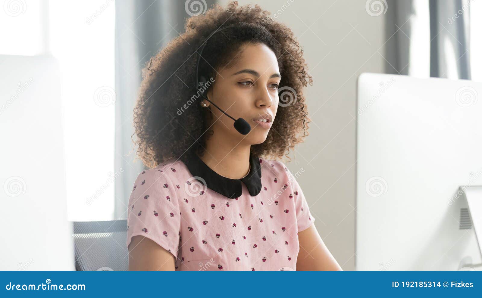 African American Female Call Center Operator in Headset Using Computer ...