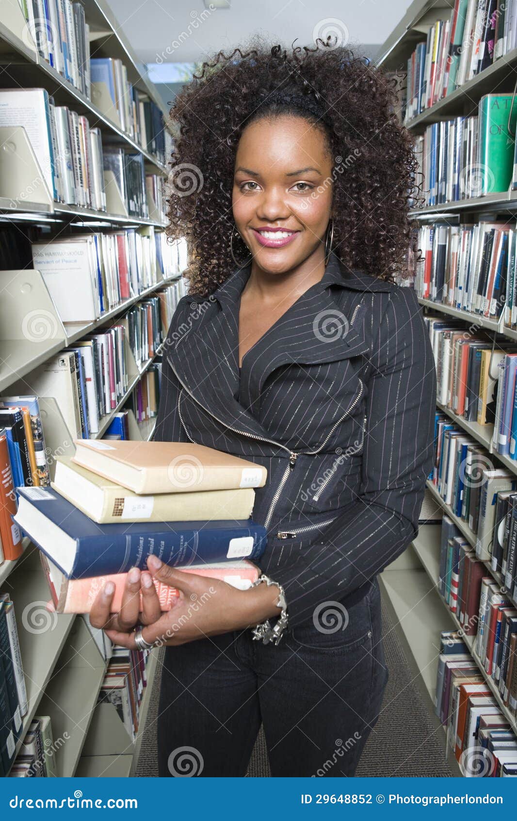 African American Female Holding Stack of Books Stock Photo - Image of ...
