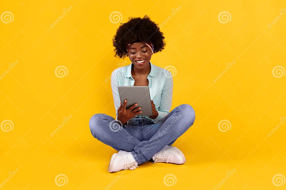 African American Female Using Tablet Computer Browsing Internet, Pink ...