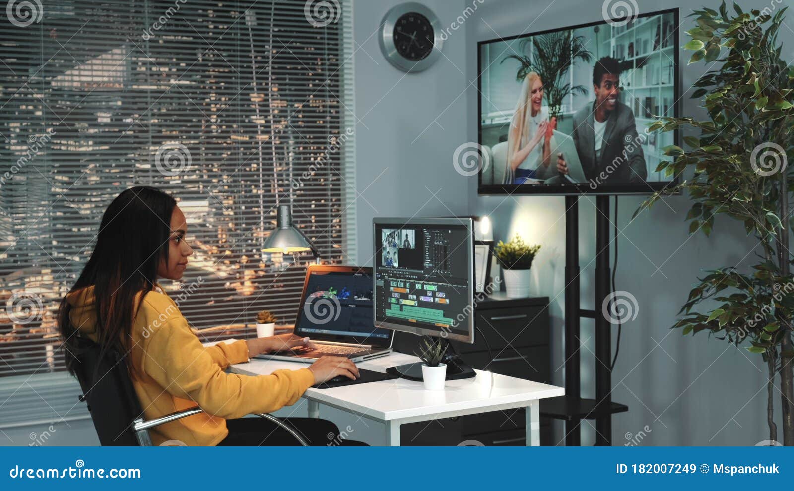 African American Female Video Editor Works on the Computer and Mounts ...