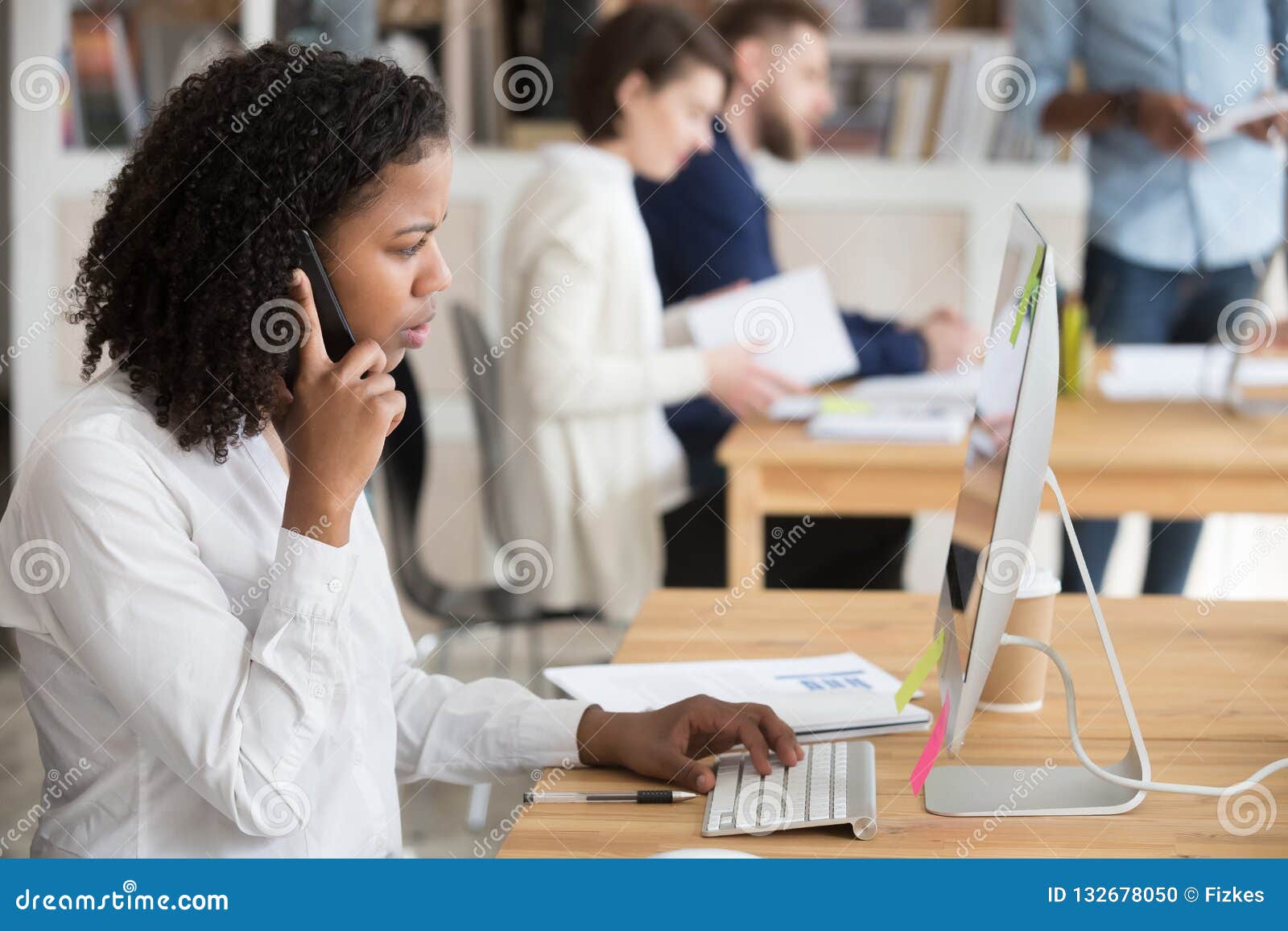 African American Female Worker Consulting Client by Phone Stock Photo ...