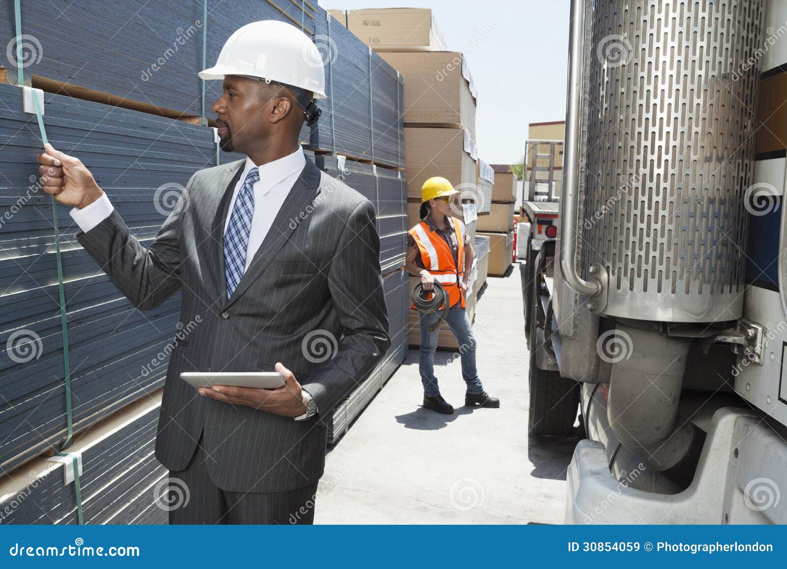 African American Male Engineer Inspecting Planks while Female Worker ... African American Male Engineer Inspecting Planks while Female Worker ...