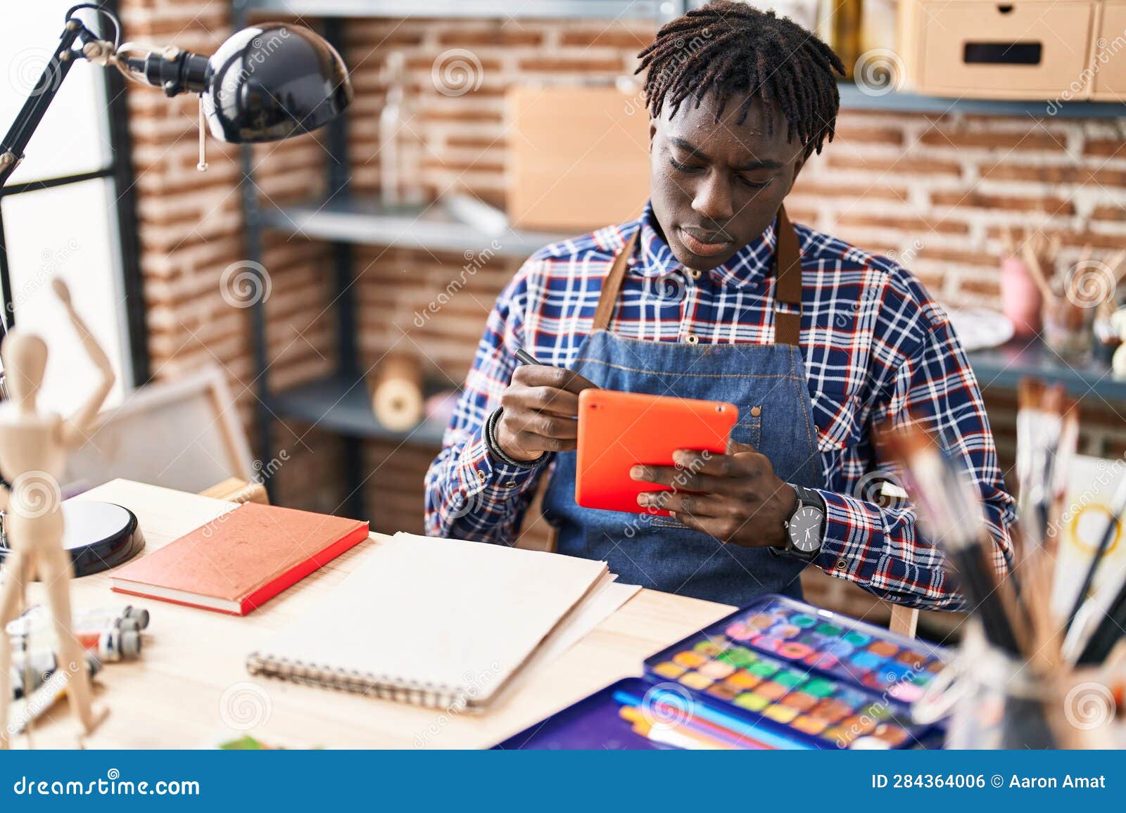 African American Man Artist Drawing on Touchpad at Art Studio Stock ...