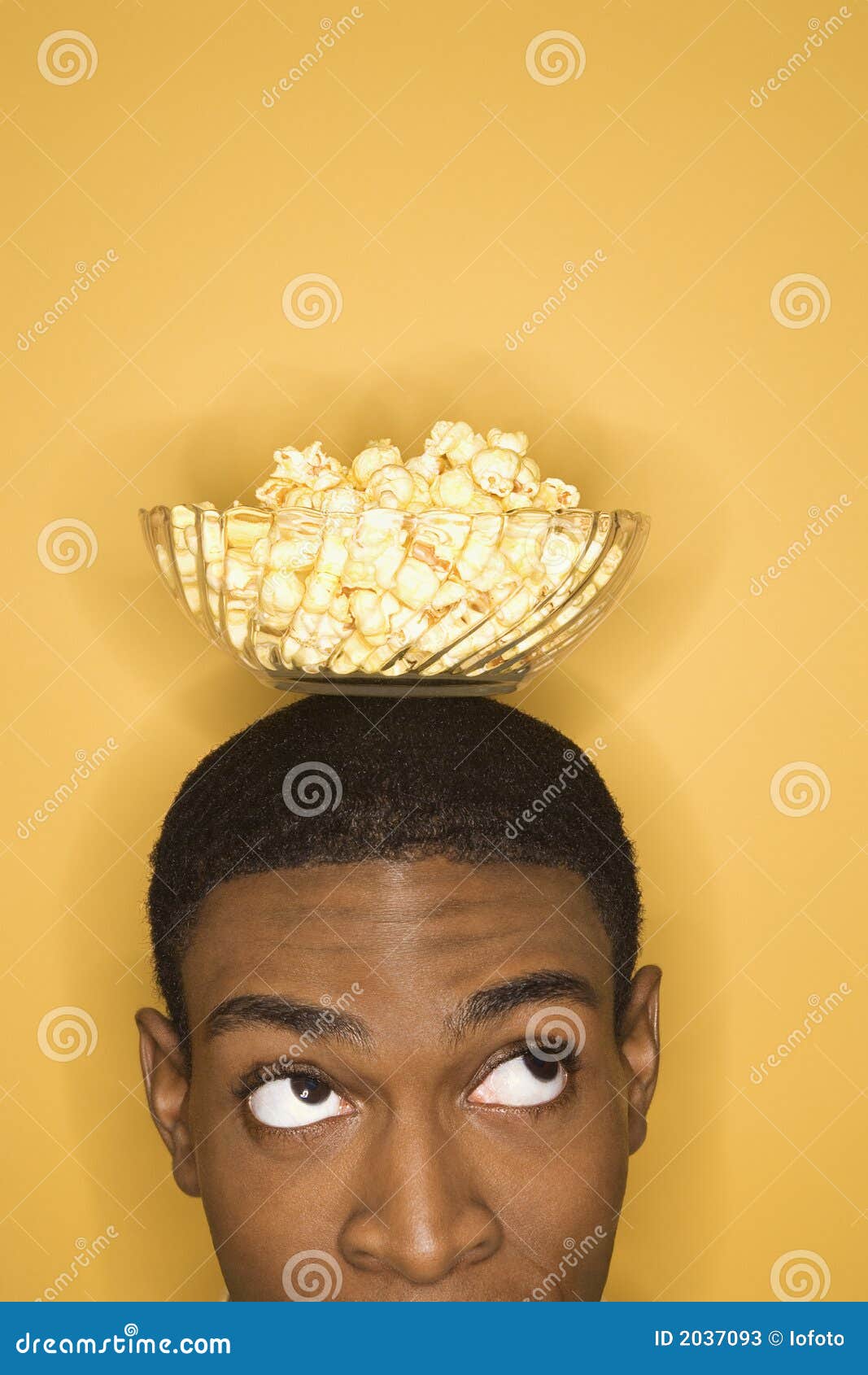 African-American Man Balancing Bowl of Popcorn on Head. Stock Image ...