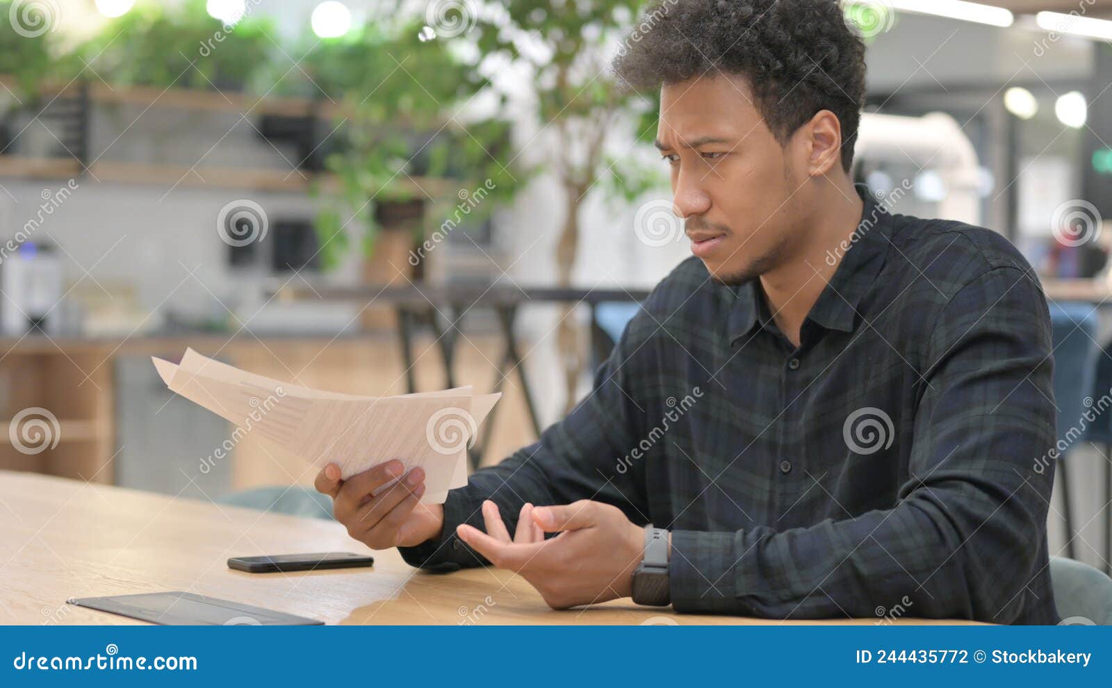 African American Man Having Loss while Reading Documents Stock Photo ...