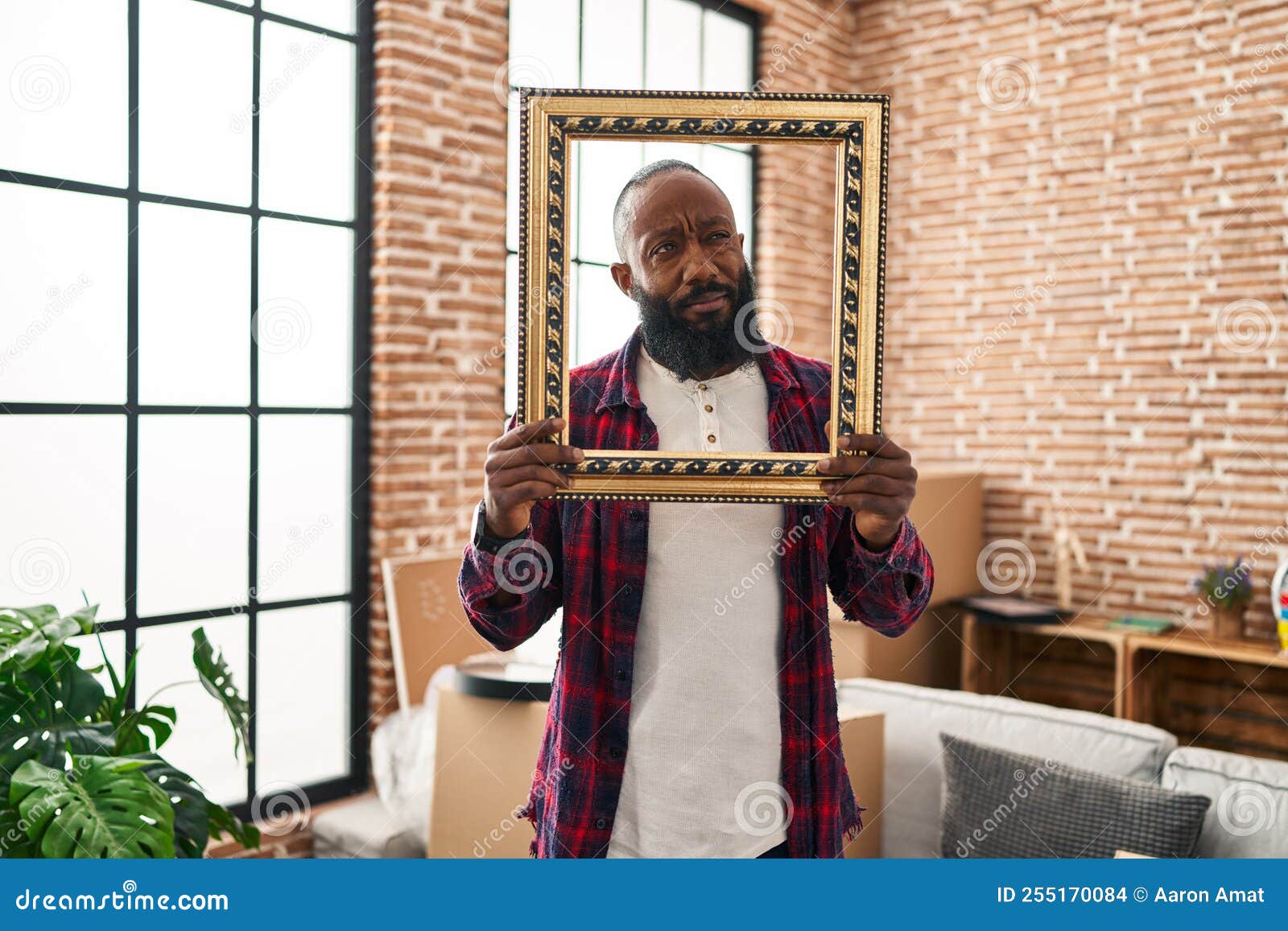 African American Man Putting Face in Empty Frame Smiling Looking To the ...