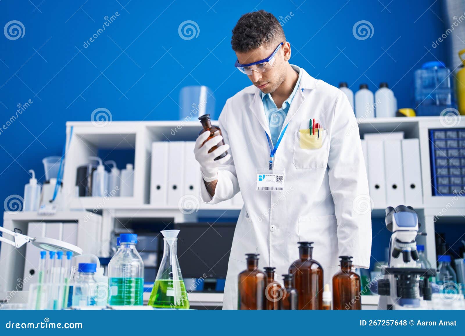 African American Man Scientist Holding Bottle at Laboratory Stock Photo ...