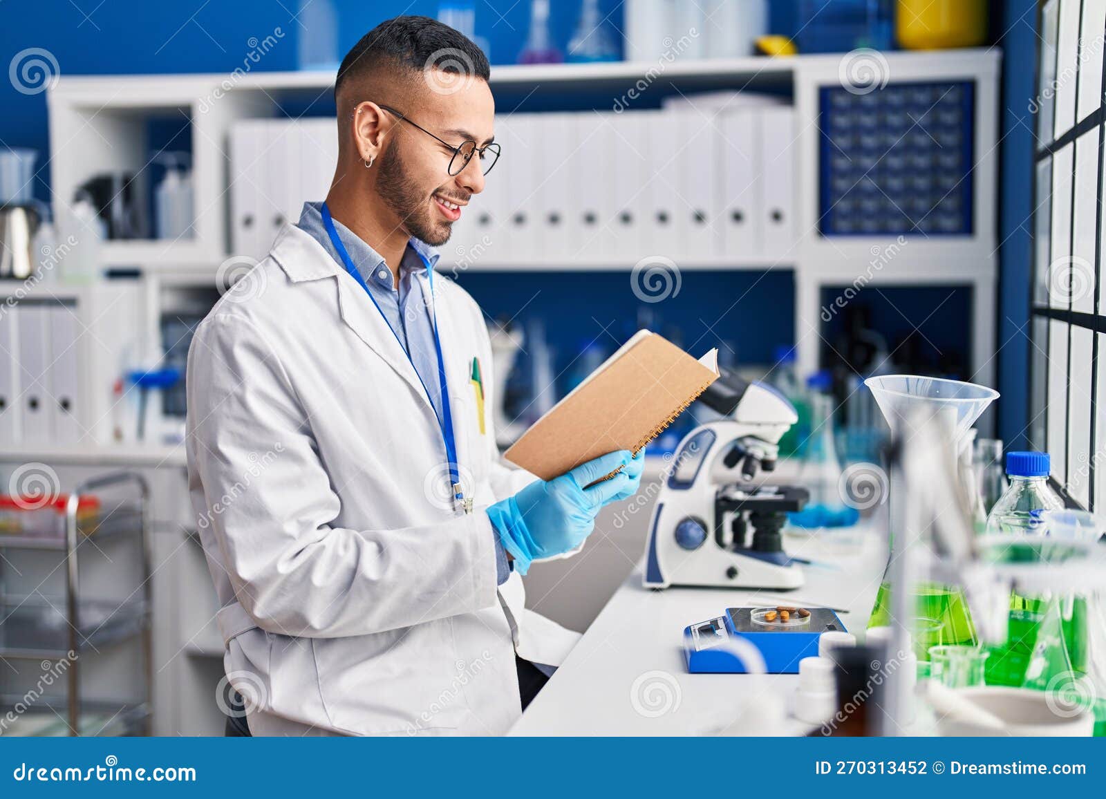 African American Man Scientist Reading Book Working at Laboratory Stock ...