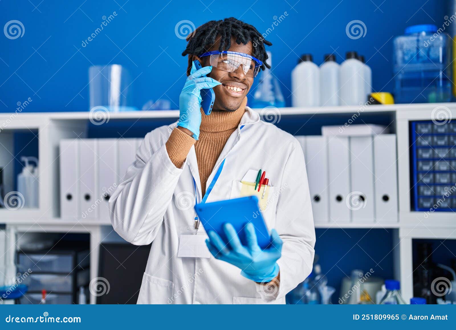 African American Man Scientist Talking on the Smartphone Using Touchpad ...