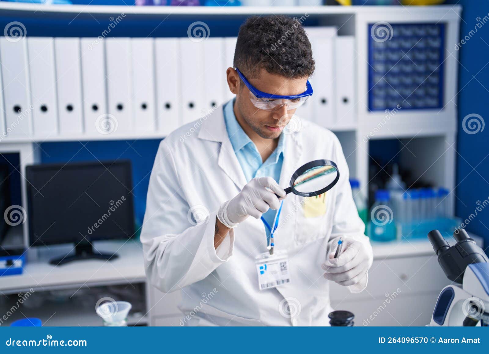 African American Man Scientist Using Magnifying Glass Working at ...